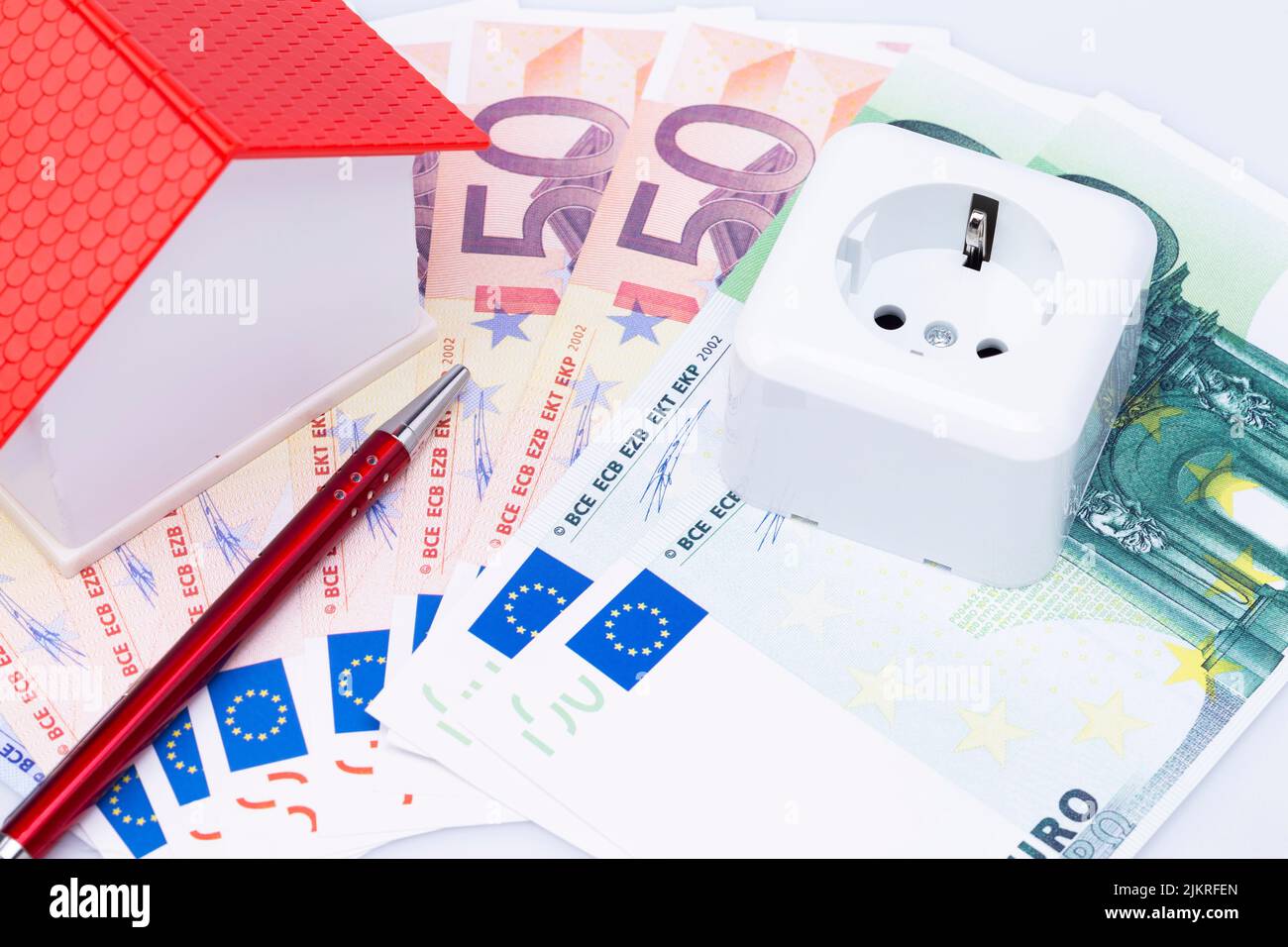 Concept photo with model house, socket, ball pen and banknotes Stock ...