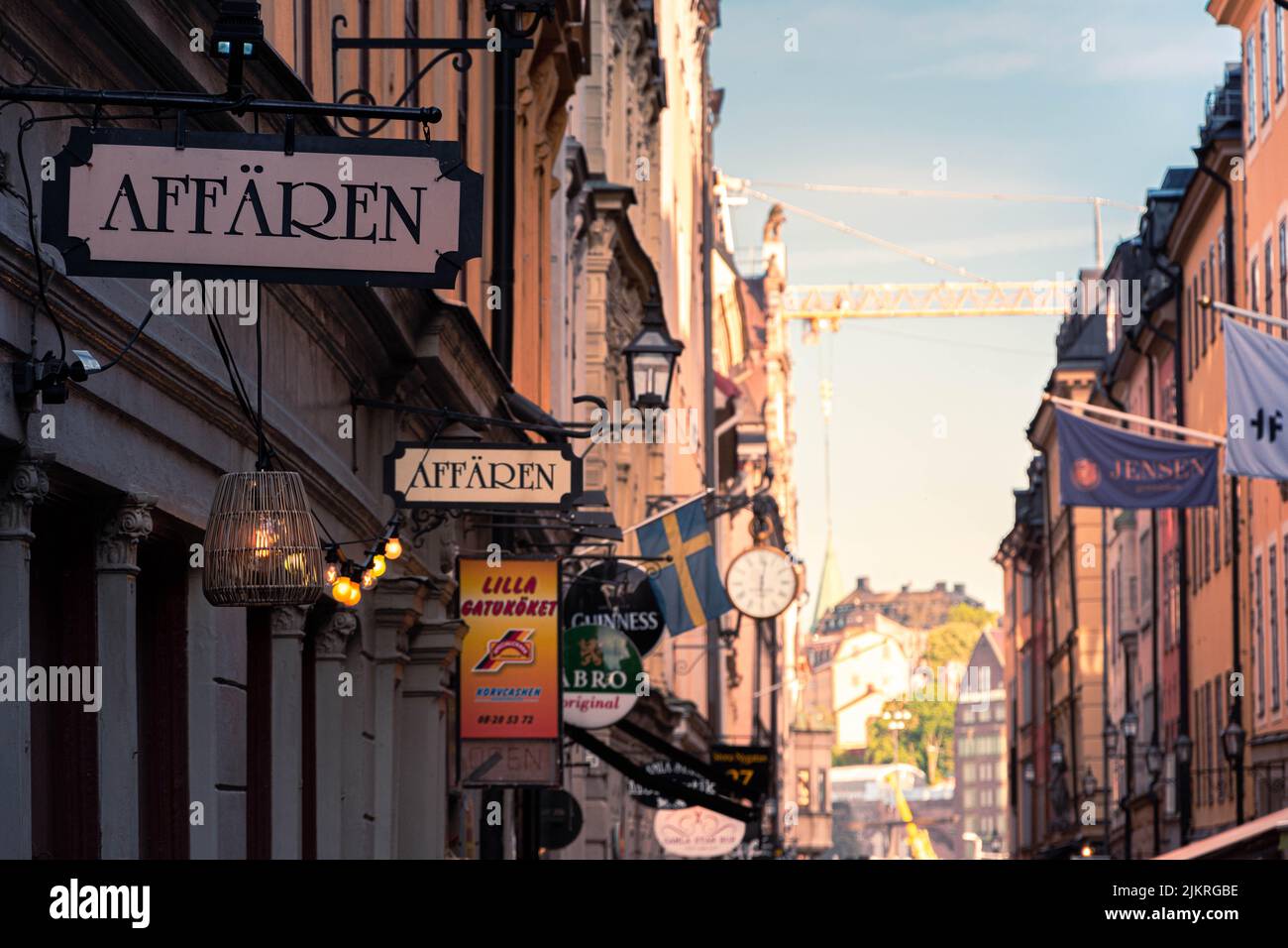 Signs over the different shops in the old town Stock Photo - Alamy