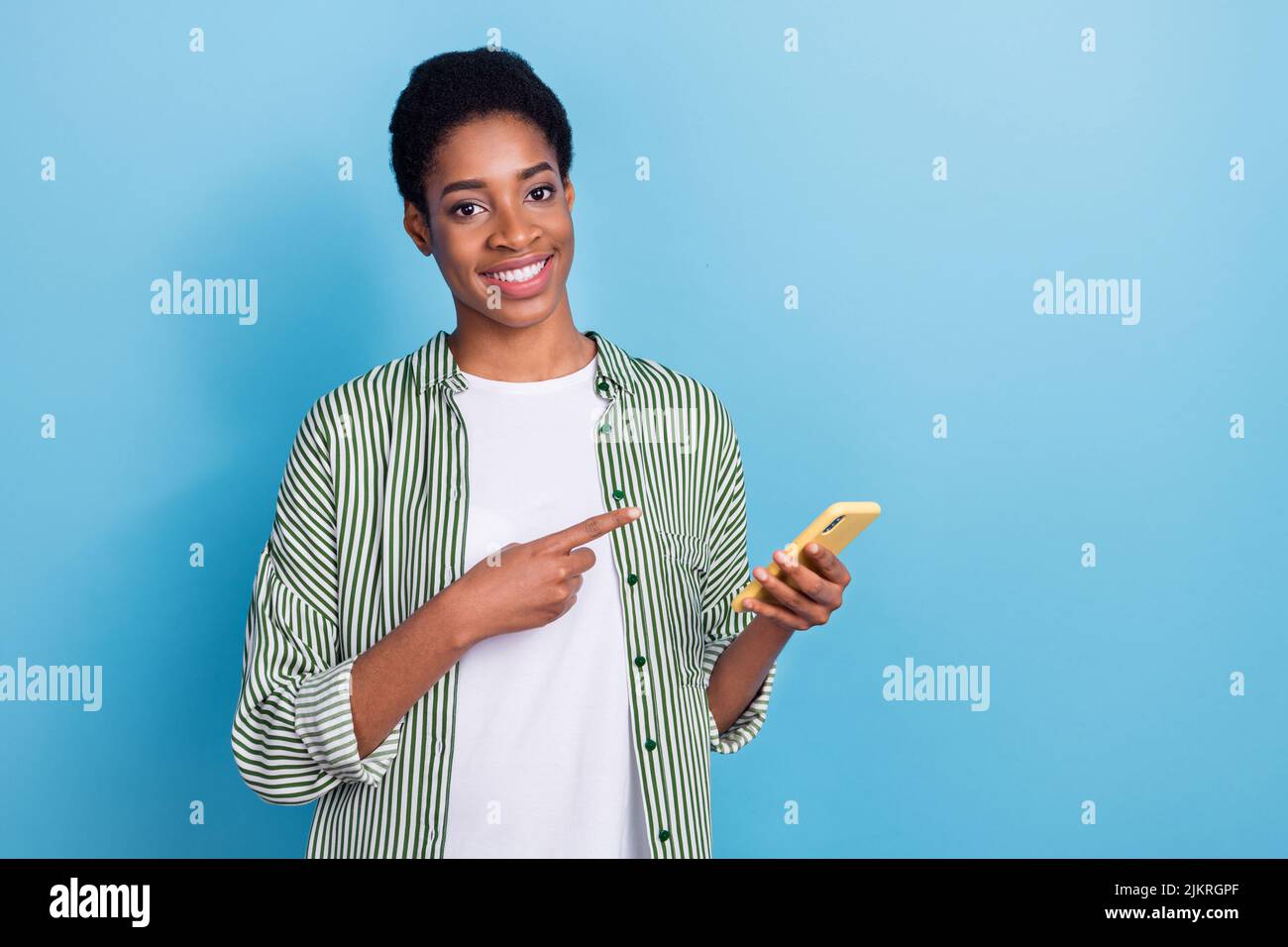 Portrait of positive satisfied person indicate finger empty space ...