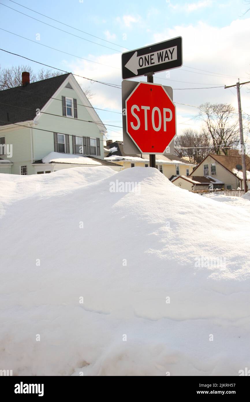 Snow covered traffic stop sign in residential area Stock Photo - Alamy
