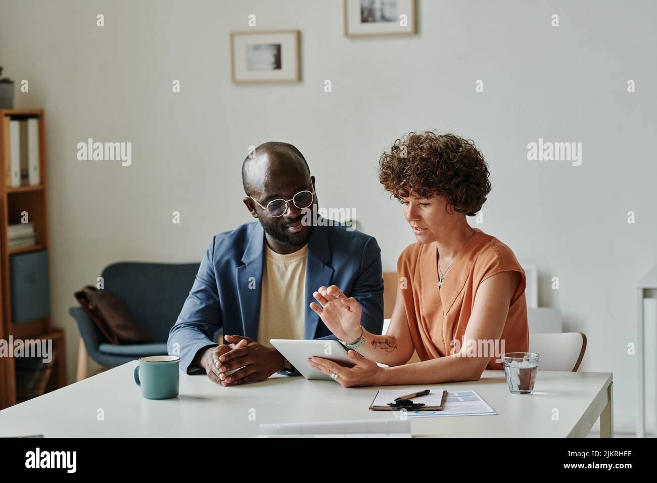 Young businesswoman discussing online project on digital tablet ...