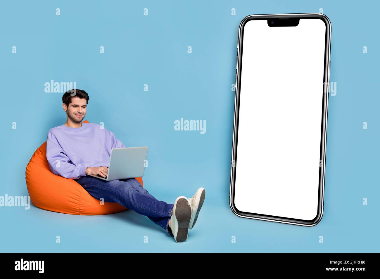 Photo of guy sit bag chair remote speak client use netbook billboard ...