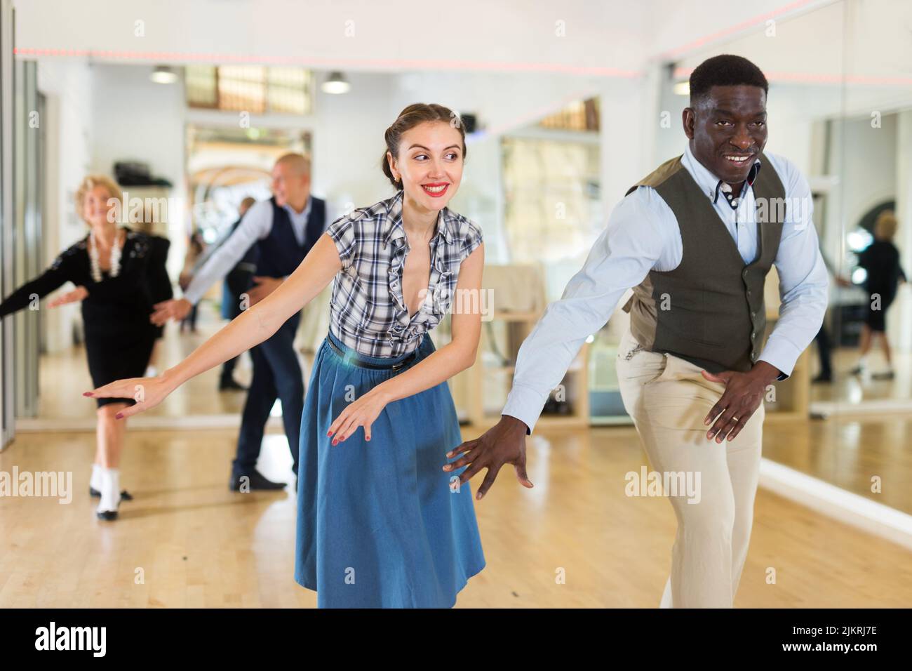 Woman with african man practising charleston dancing Stock Photo - Alamy