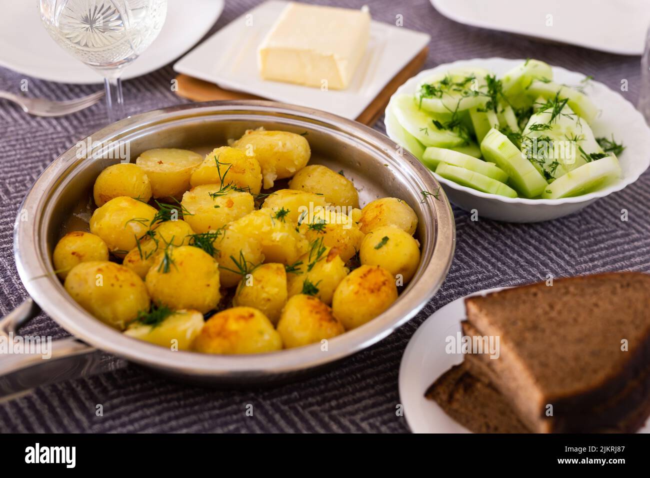 toasted young potatoes with dill in metal skillet Stock Photo - Alamy