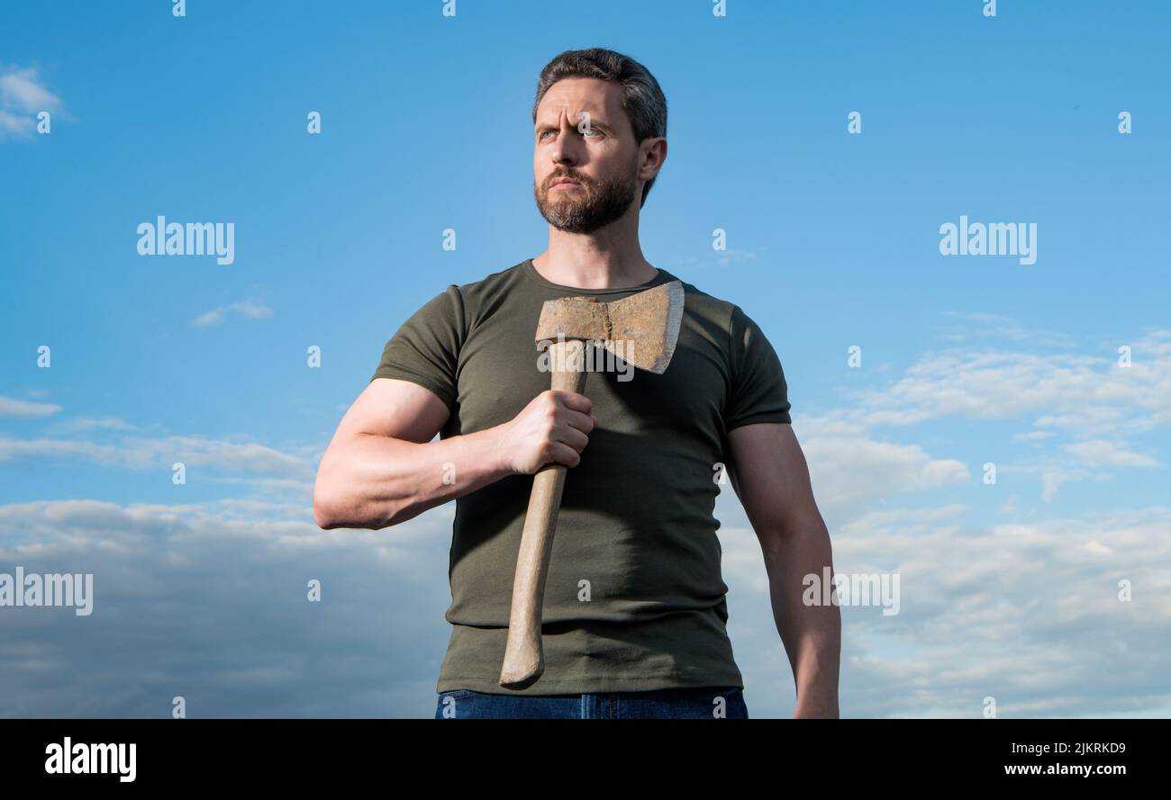 strong man with axe. confident man hold ax. brutal man on sky ...