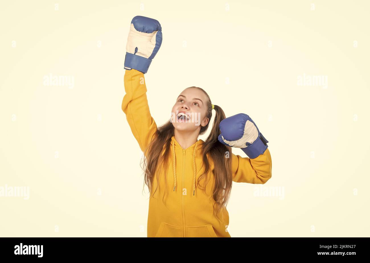 happy kid boxer in boxing gloves celebrating victory in fight isolated ...