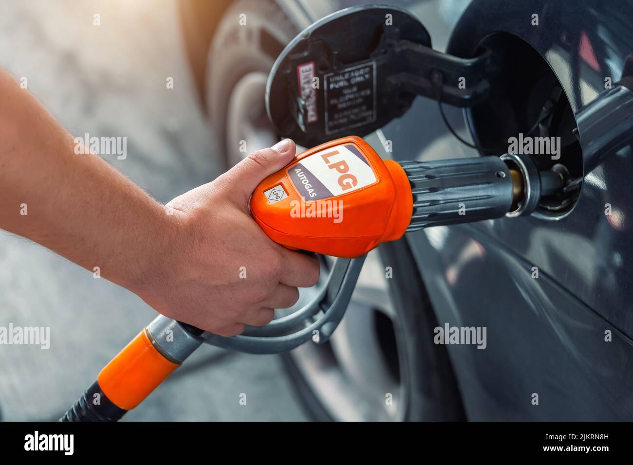 Close-up detail view of fuel autogas pump gun connected with noozle ...