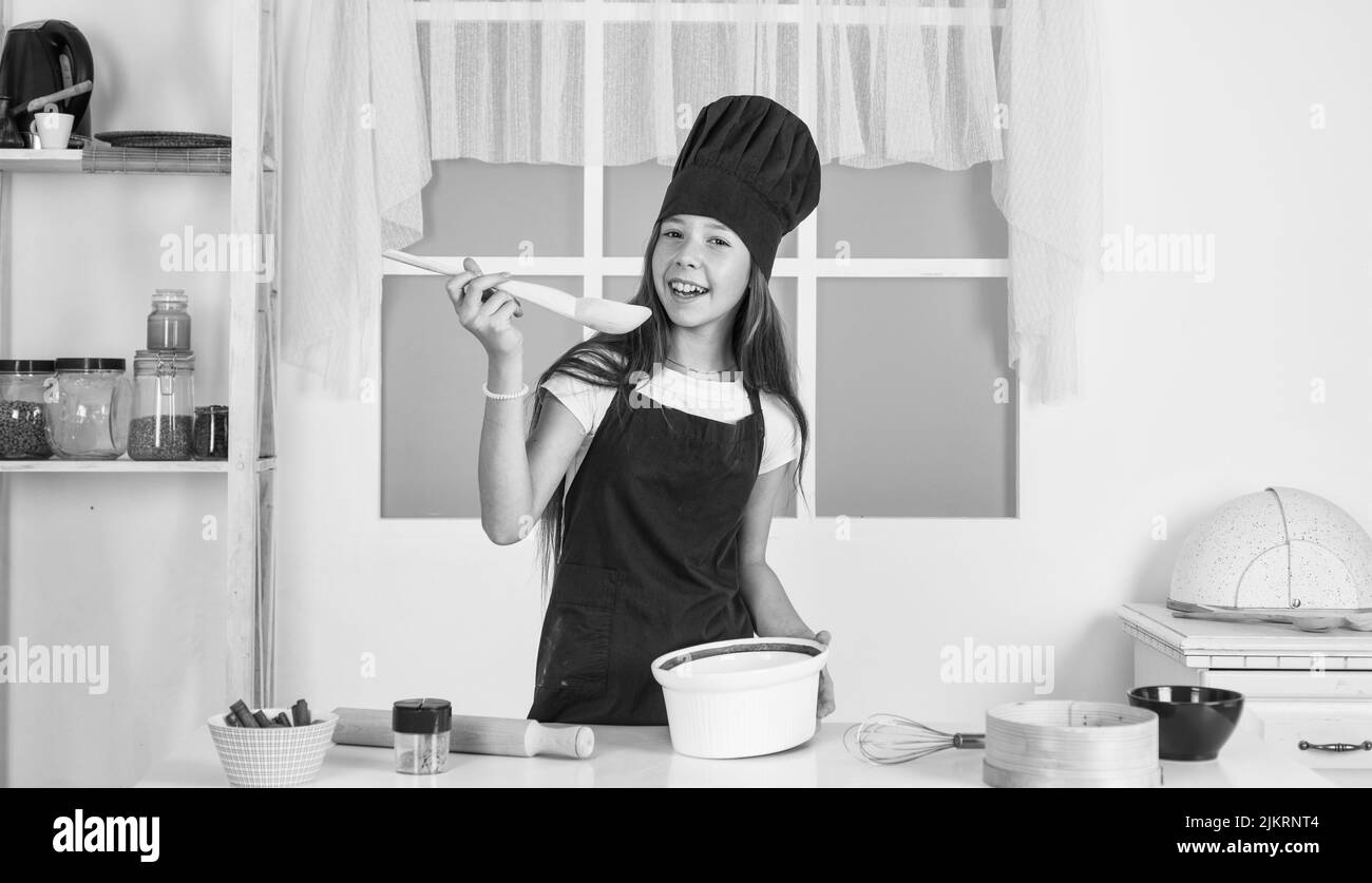 girl kid in chef apron and hat cooking, bakery Stock Photo - Alamy