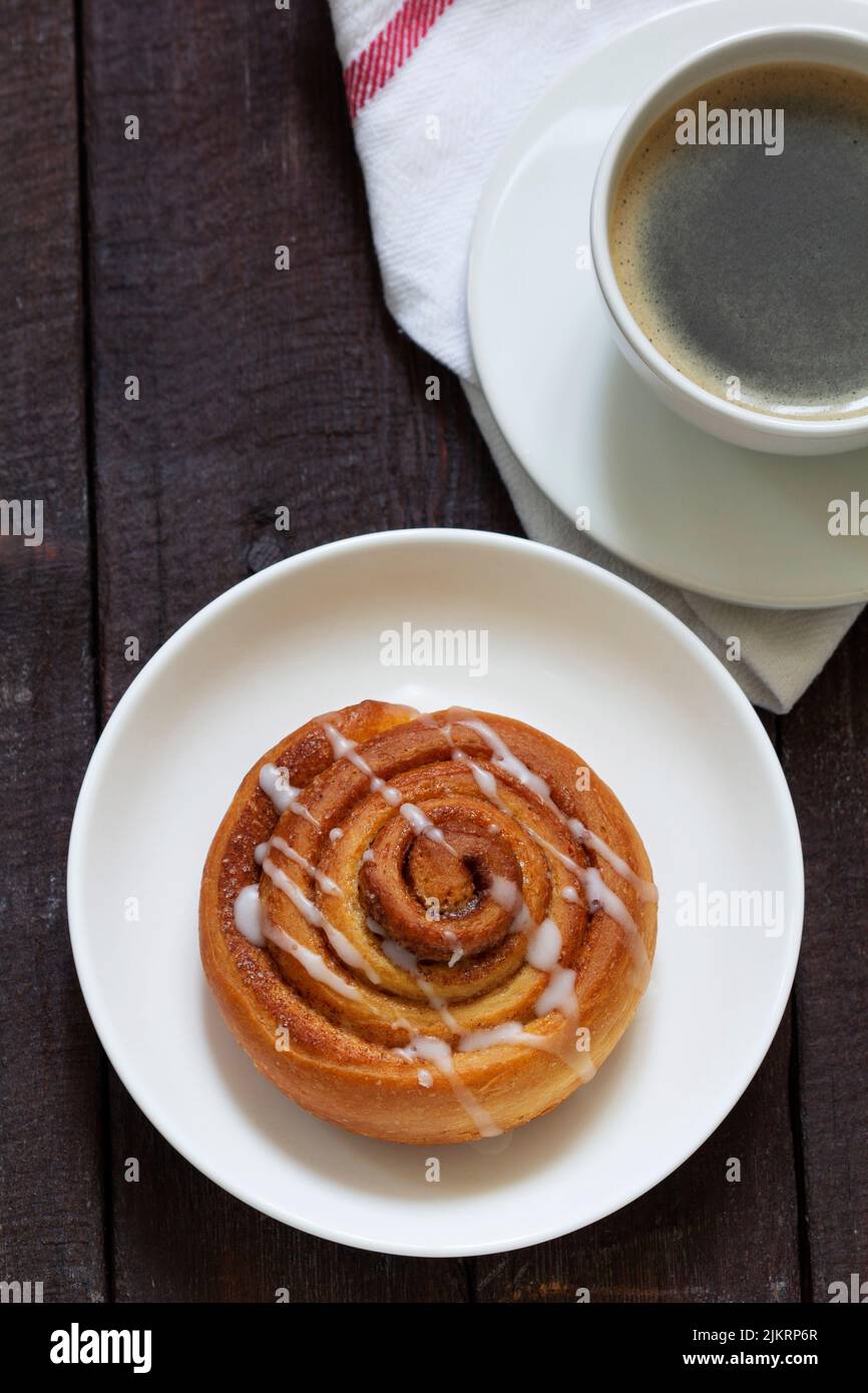 Cinnamon buns with icing served with coffee. Rustic style Stock Photo ...
