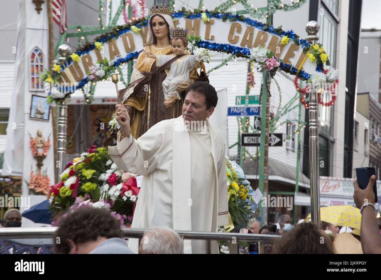 Priests lead a procession outside Our Lady of Mount Saint Carmel Church at the during the annual ...