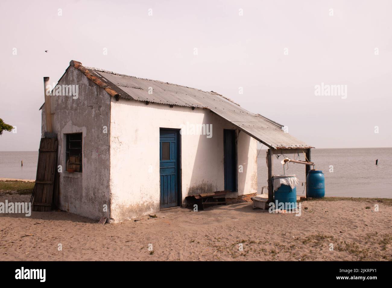 Simple white house by the sea Stock Photo - Alamy