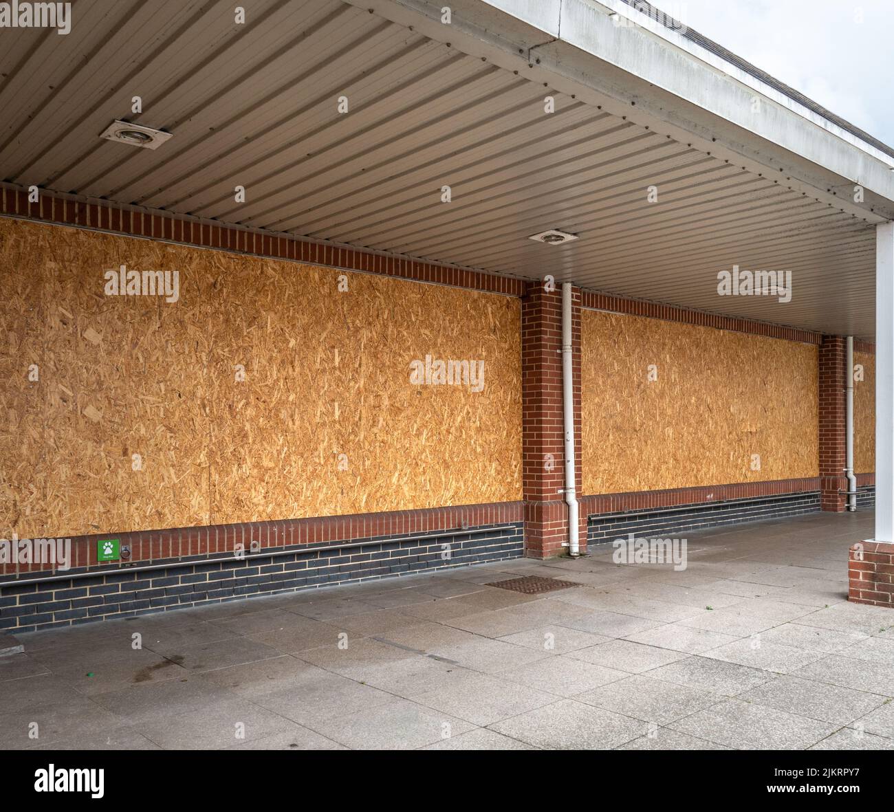 Boarded up windows of a supermarket that has recently closed down Stock ...
