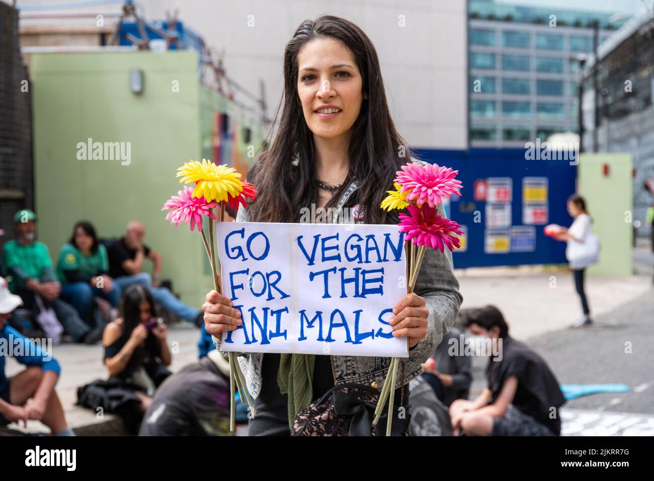 vegan activist standing with placard London 2021 Stock Photo - Alamy
