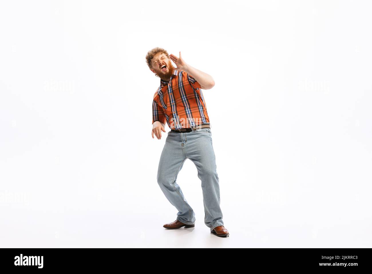 Portrait of young man dressed in 50s, 60s fashion style outfit posing ...