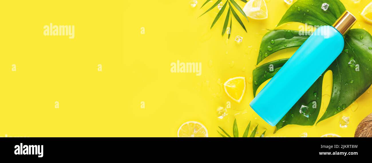 Cosmetic banner with blue cosmetic bottle with slices of citrus fruits ...
