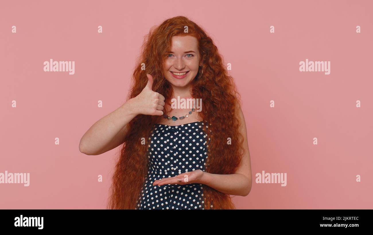 Look at advertisement. Subscribe. Redhead woman pointing down, saying ...