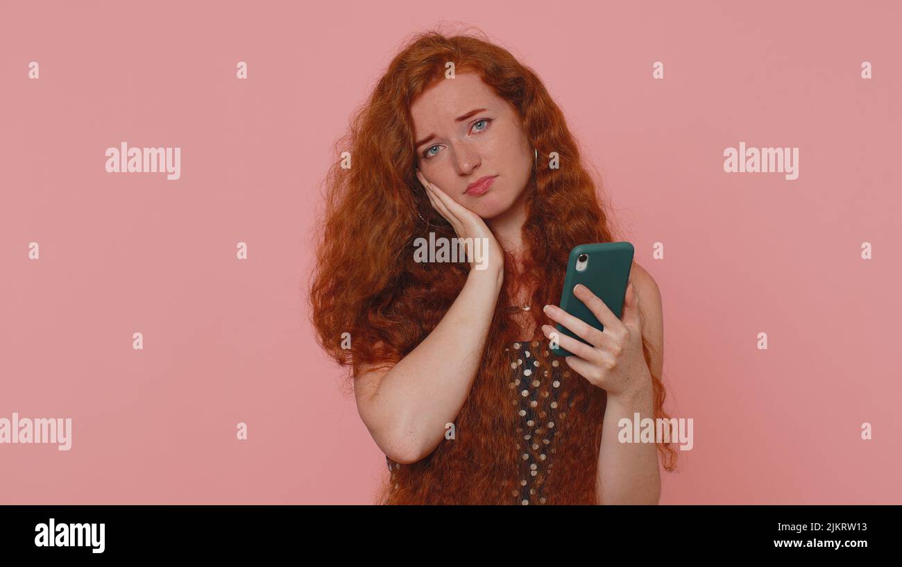 Unhappy Sad Young Redhead Woman Use Smartphone Typing Browsing Loses