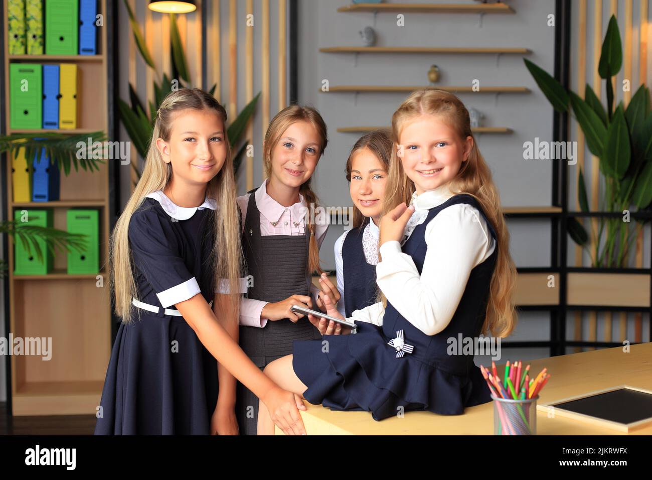 Young female students in school uniforms before the lesson in the ...