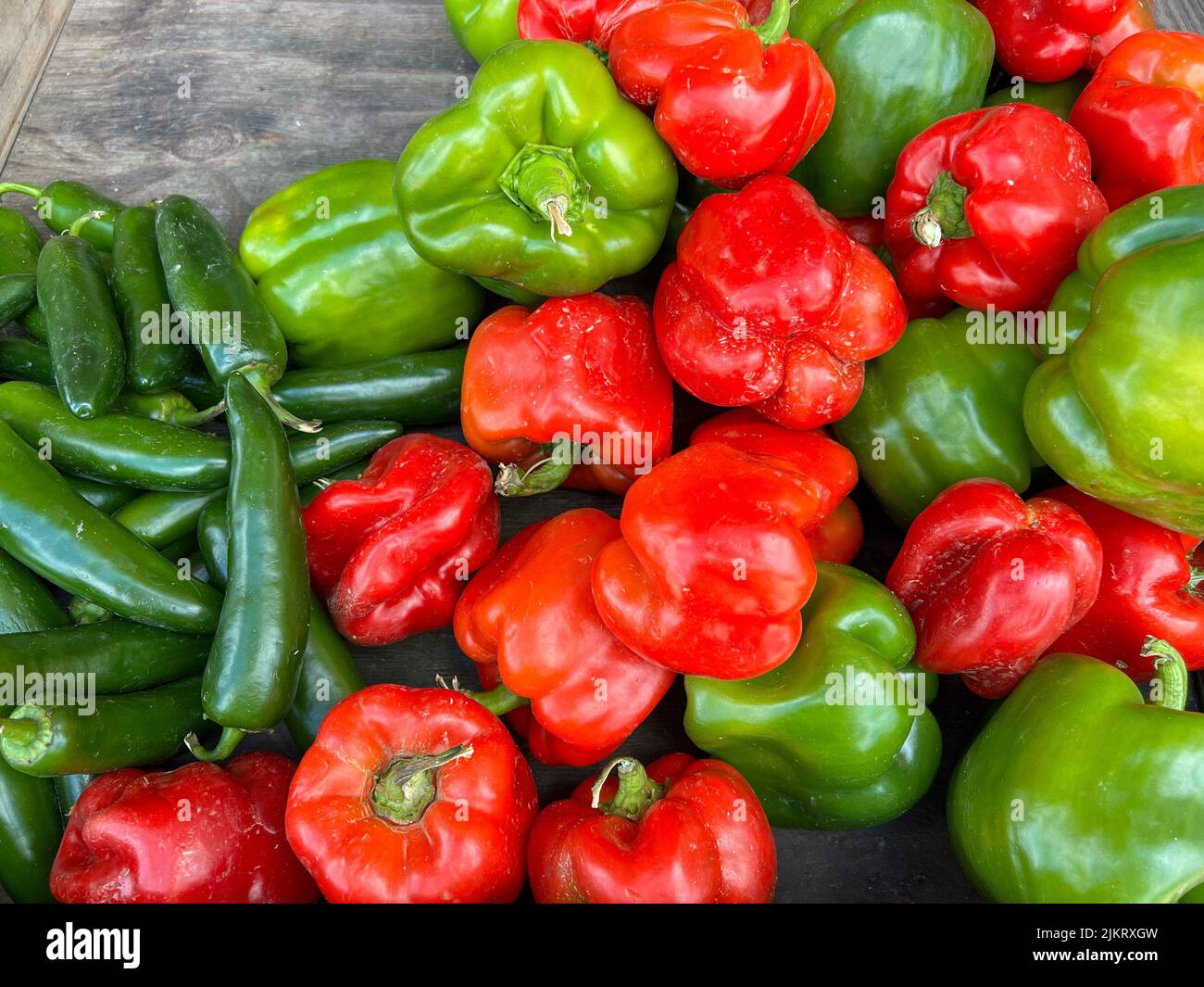 Bright red and green Florida peppers at a fruit and vegetable stand in ...