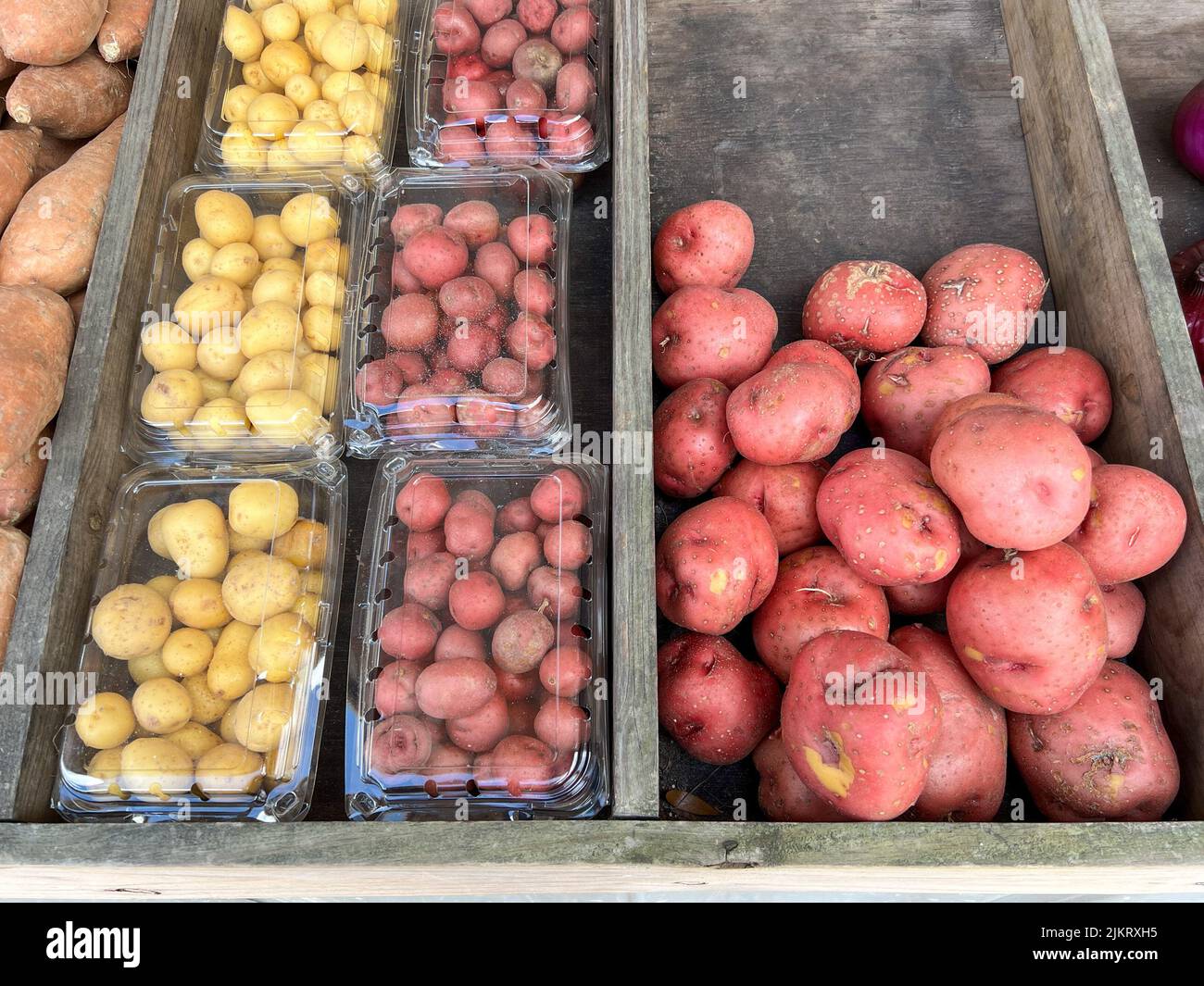 Colorful red and white potatoes at a fruit and vegetable stand in ...
