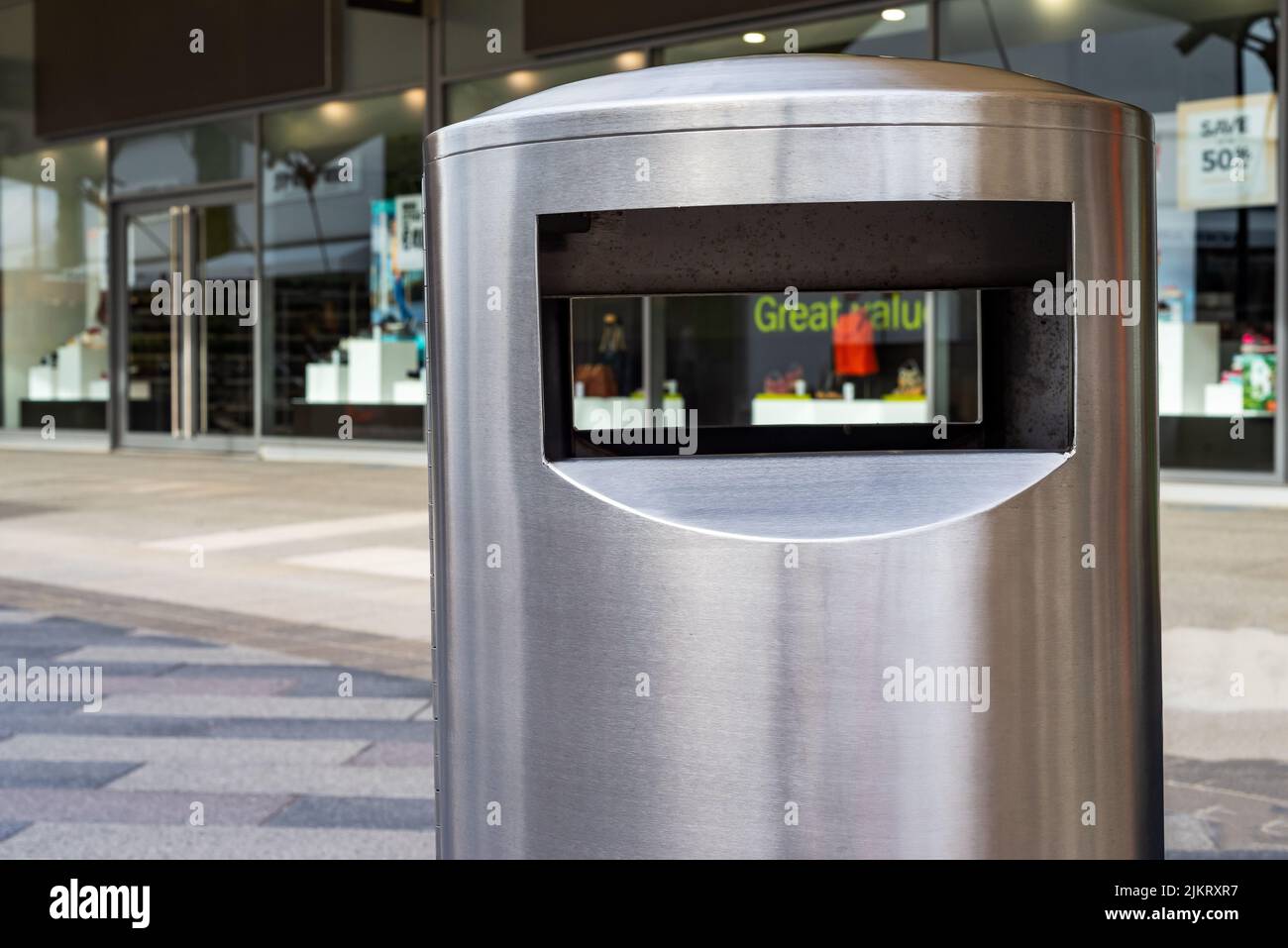 Close up of shiny silver chrome public waste bin, ashtray, located on ...