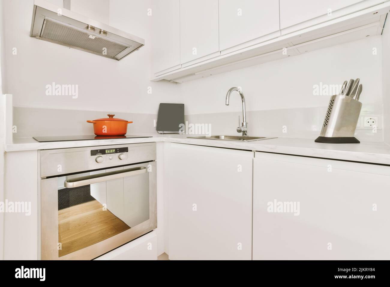 Fragment of interior of light narrow home kitchen with minimalist style ...