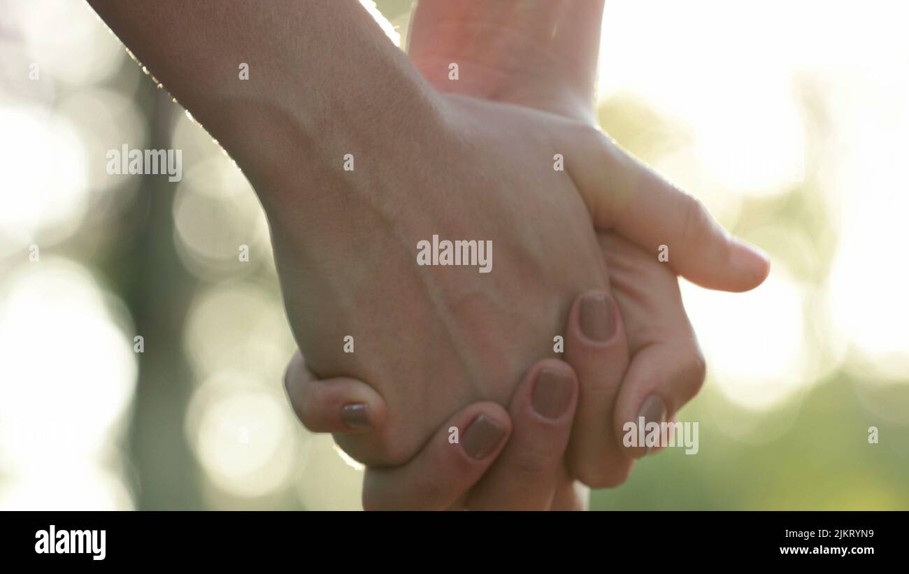 Joining hands together uniting the chain from hands held together in ...