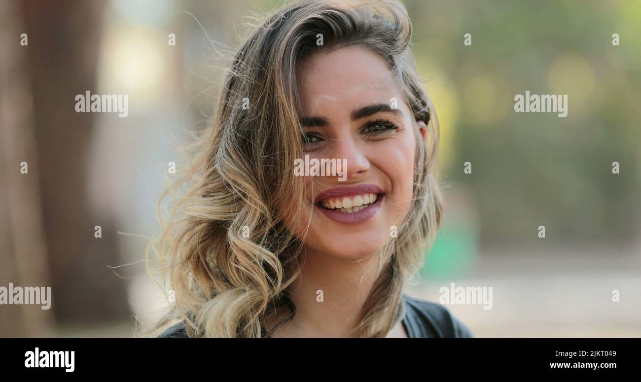 Pretty girl looks to camera laughing and smiling Stock Photo - Alamy