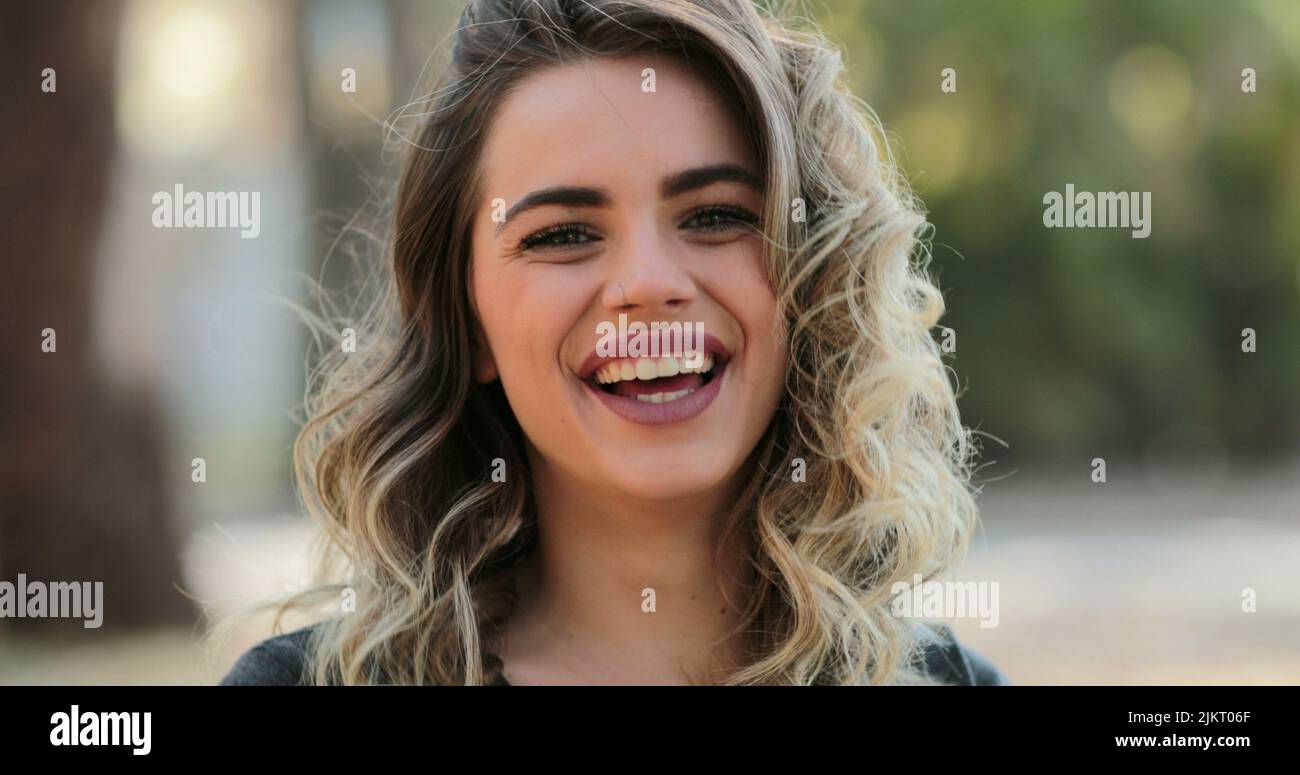 Real laugh and smile of pretty girl looking to camera Stock Photo - Alamy