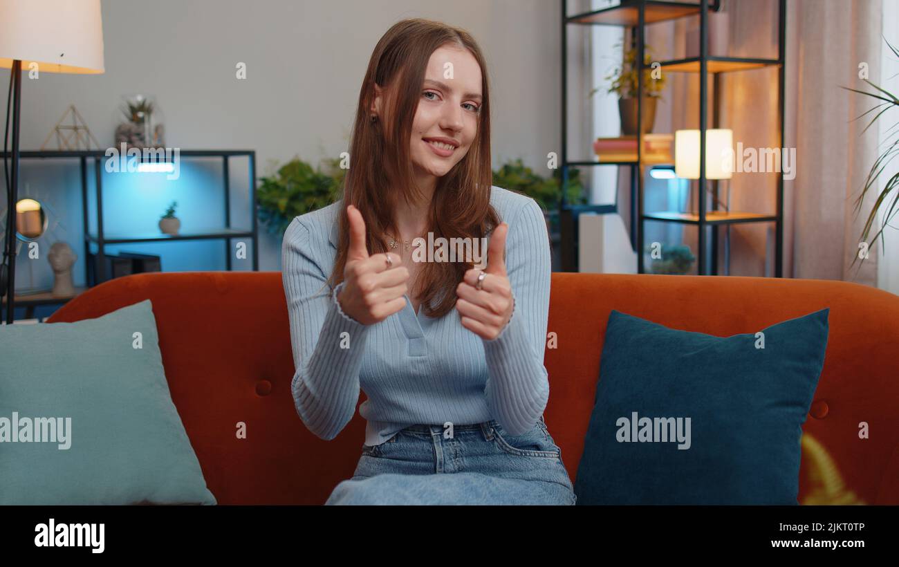 Great job. Young woman showing thumbs up and nodding in approval ...