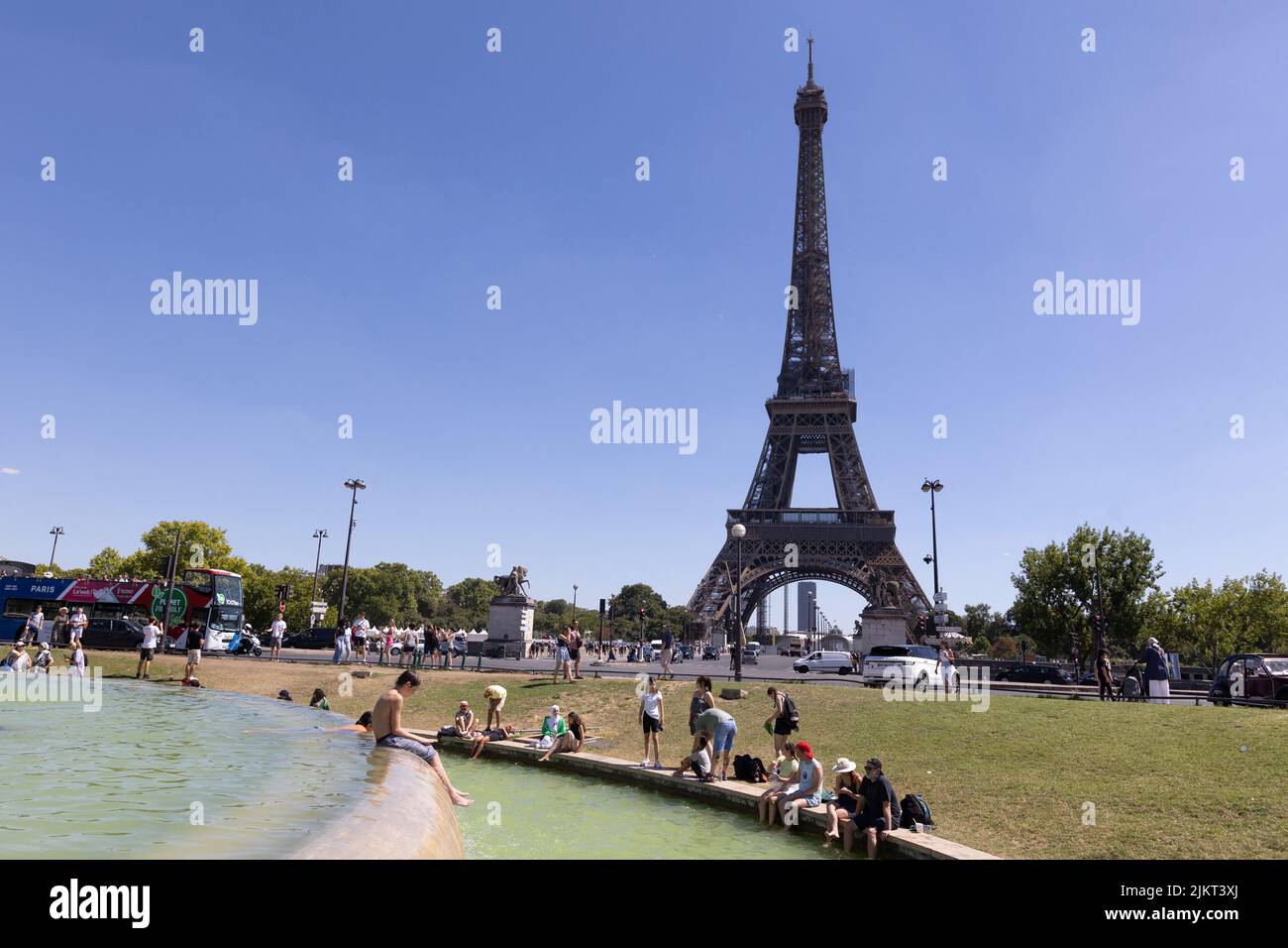 People cool off at the Trocadero fountain, with the Eiffel Tower in ...