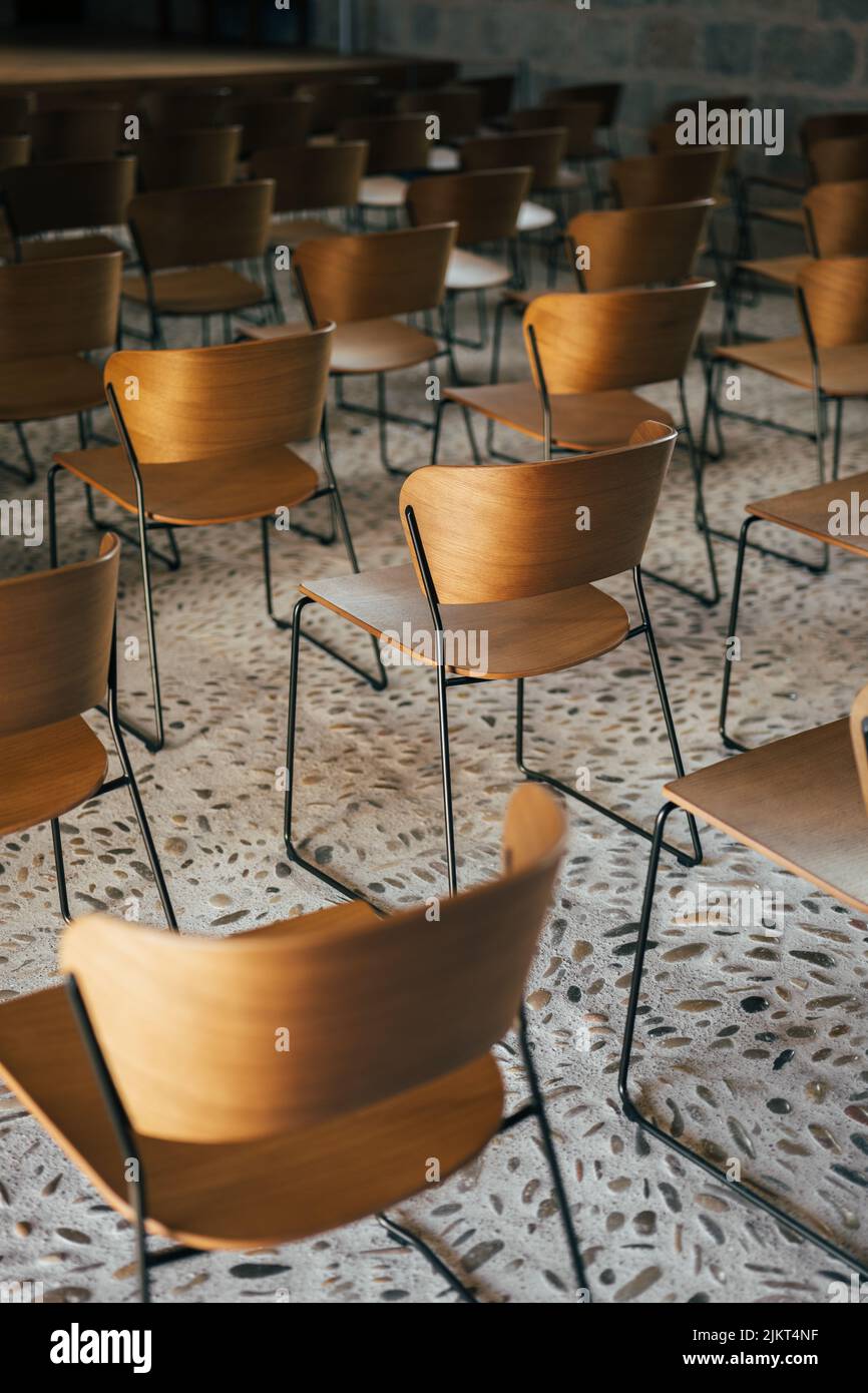 Set of empty wooden chairs lined up before an event in an ancient ...