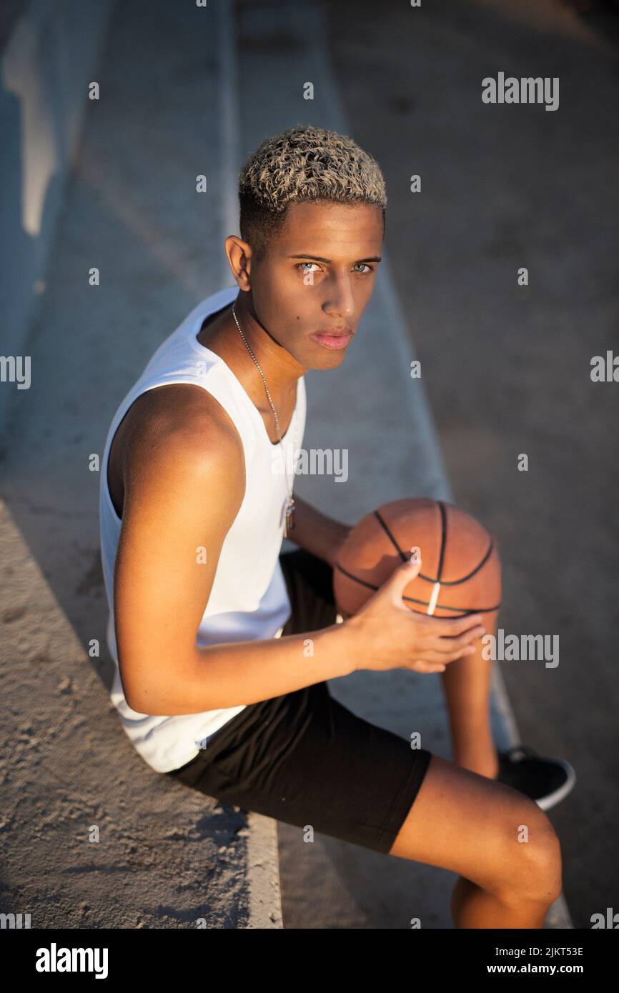 Side view of pensive African American male basketball player with ball ...