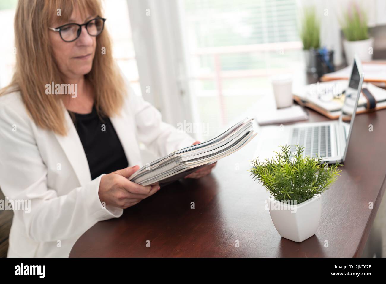 Holding magazines stack hi-res stock photography and images - Alamy