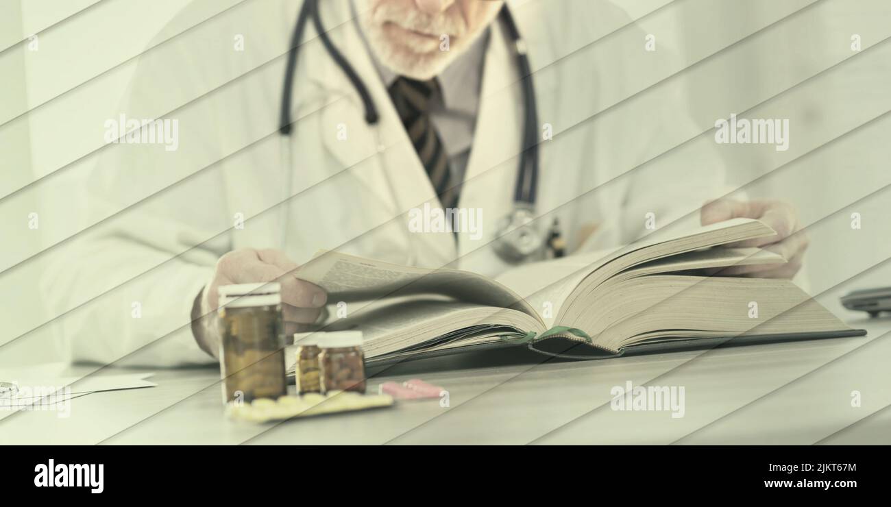 Senior doctor reading a textbook in medical office, geometric pattern ...