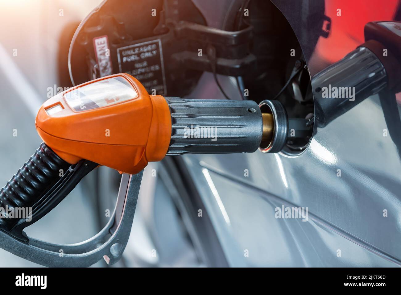 Close-up detail view of fuel autogas pump gun connected with noozle ...