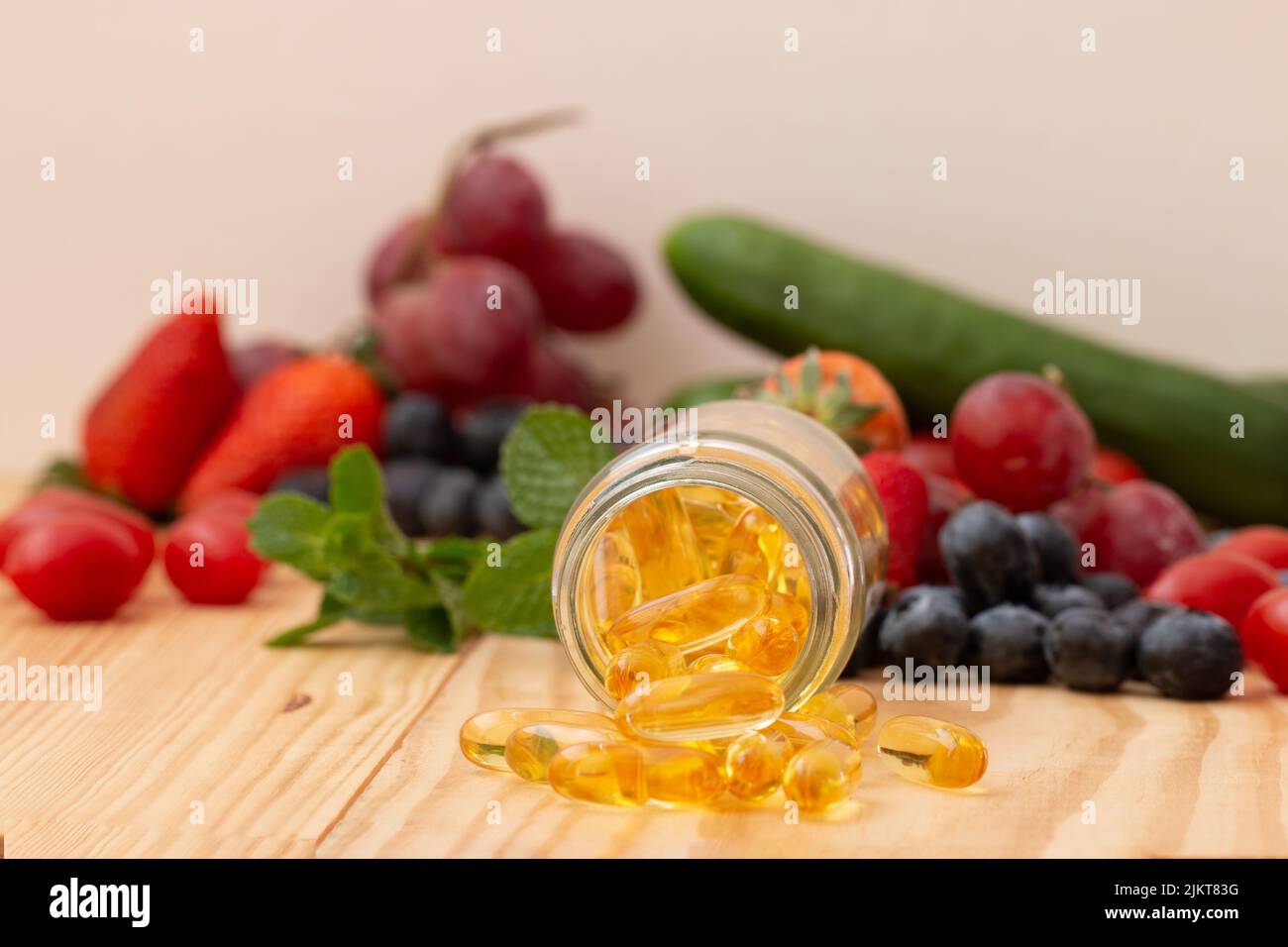 Fish oil, omega 3 with vitamin Dcapsules in the glass bottle on wooden ...