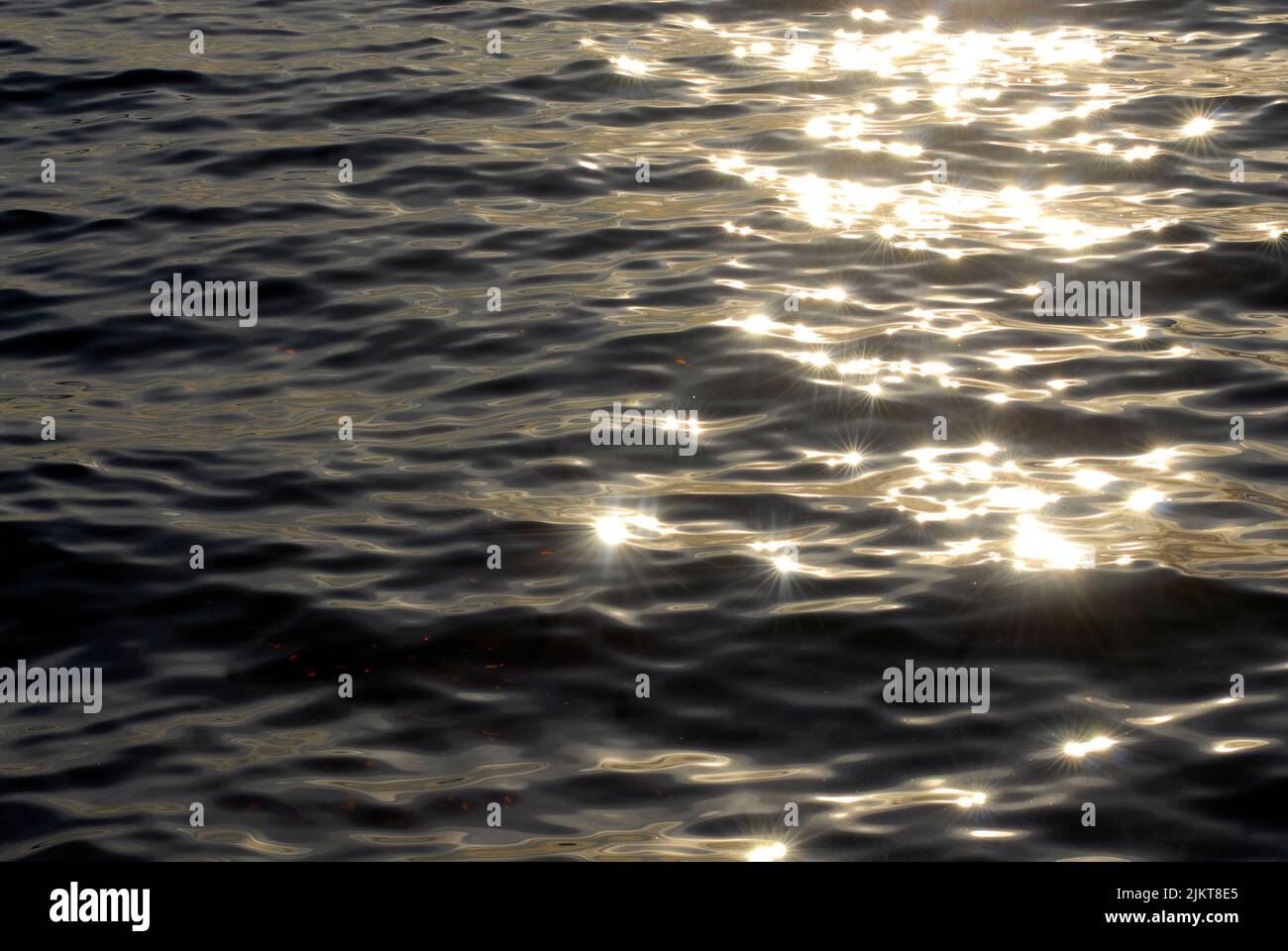 The sunset light sparkling over the ocean water in Hermosa Beach ...