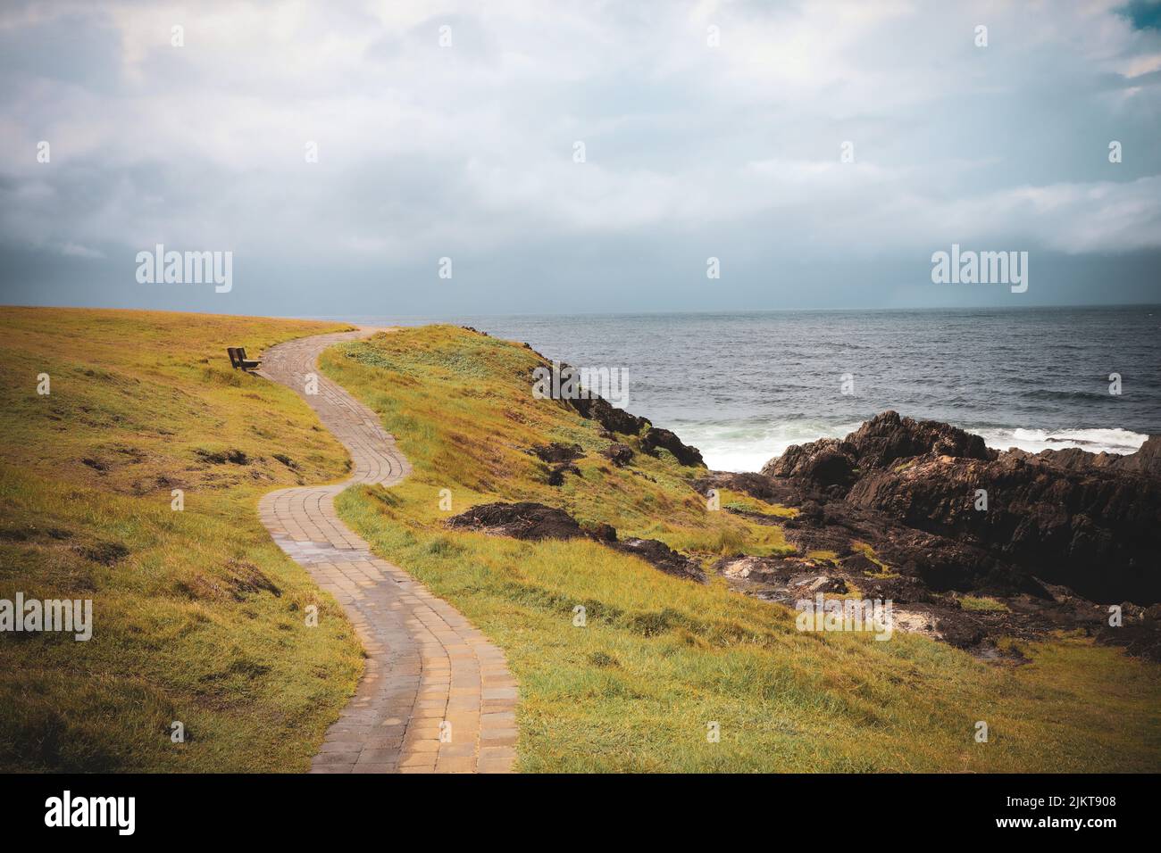 A stone walking path with two sides surrounded by lawn in the ...