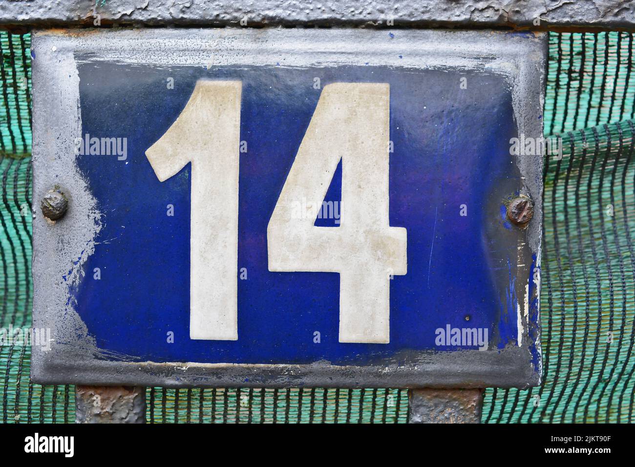 A close-up shot of the number 14 metallic signboard Stock Photo - Alamy