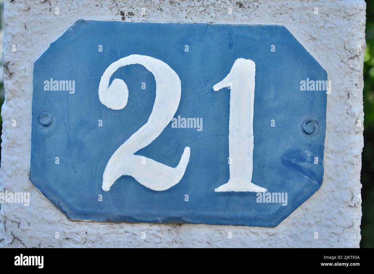 A close-up shot of the number 21 metallic signboard on the wall Stock ...