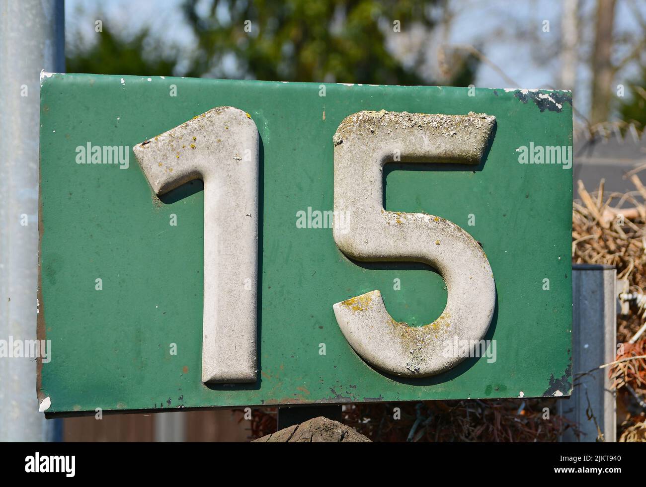 A close-up shot of the number 15 on a metallic textured signboard Stock ...