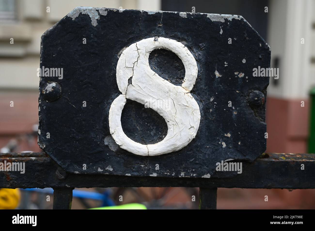 A number 8 street sign with white paint on a rustic metal surface Stock ...