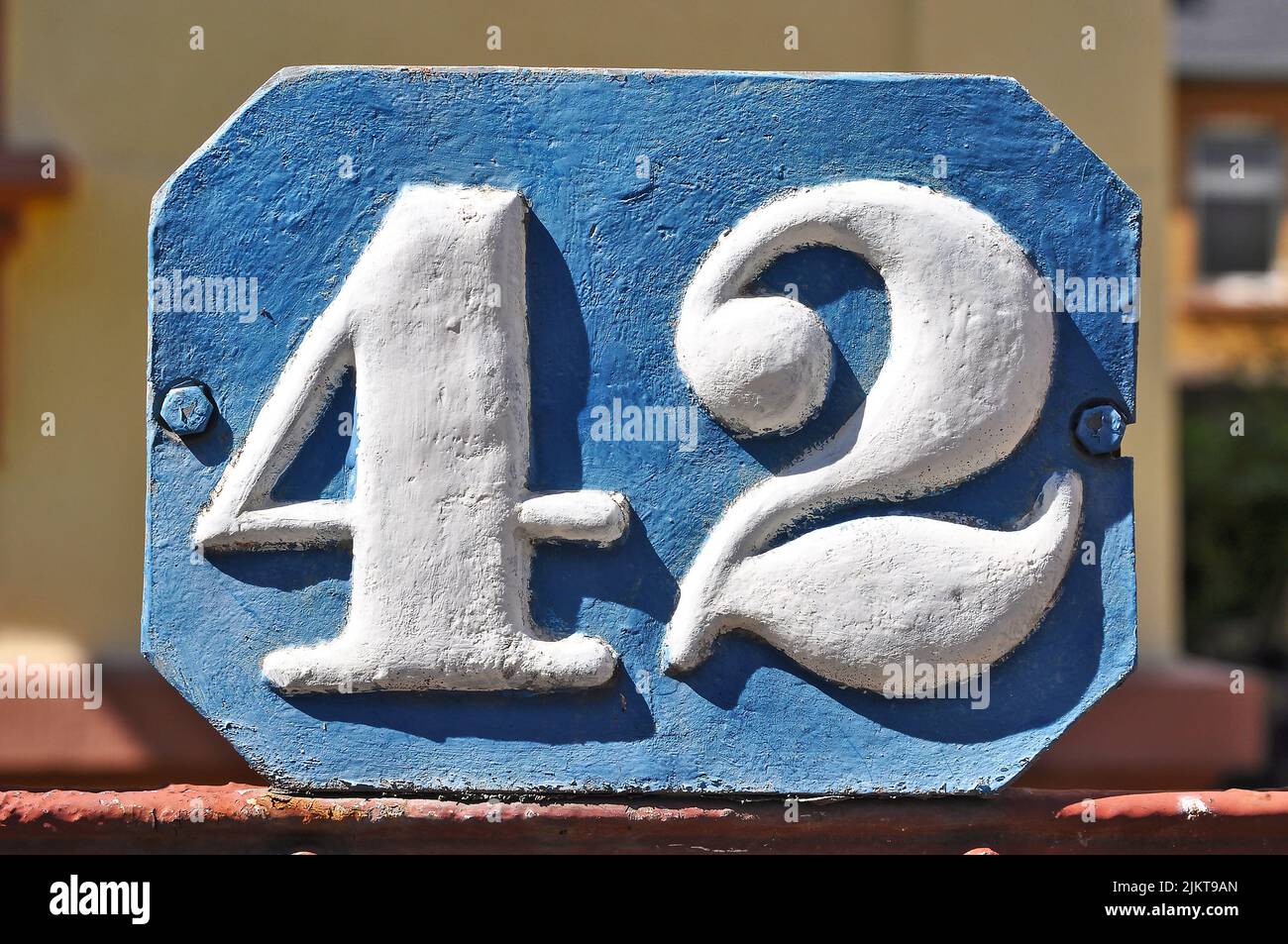 A close-up shot of the number 42 on a metallic textured signboard Stock ...