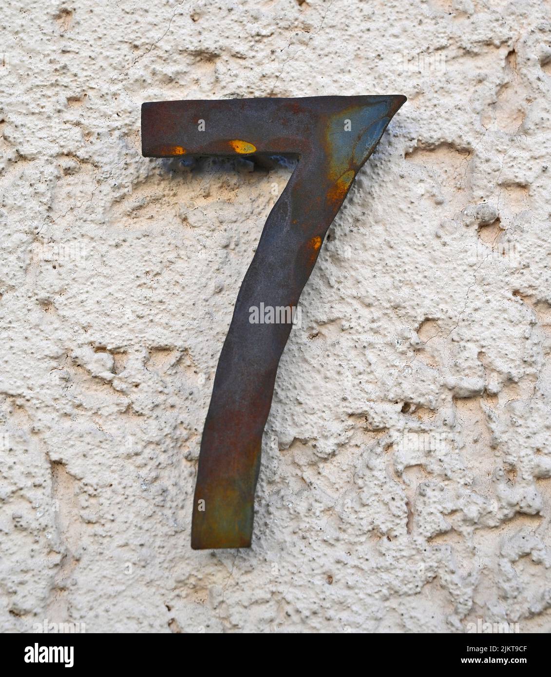 A vertical shot of a rusty-styled number 7 banner on a bumpy wall Stock ...