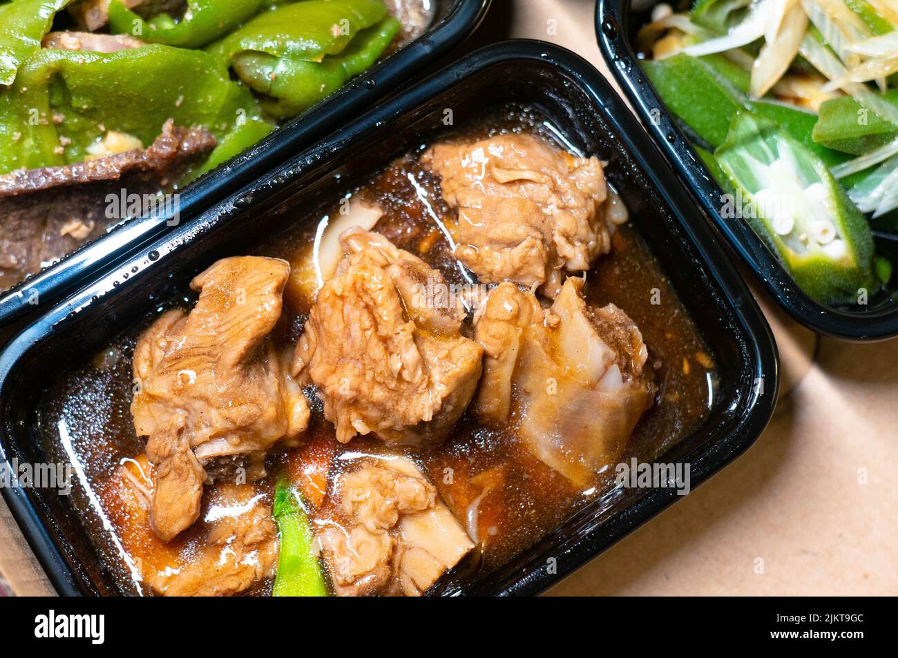 A photo of meat stew meal in a black container Stock Photo - Alamy