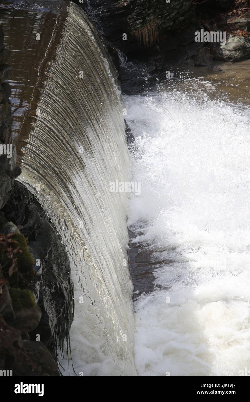 A shot of the strong flow of a water streaming down to make a river ...