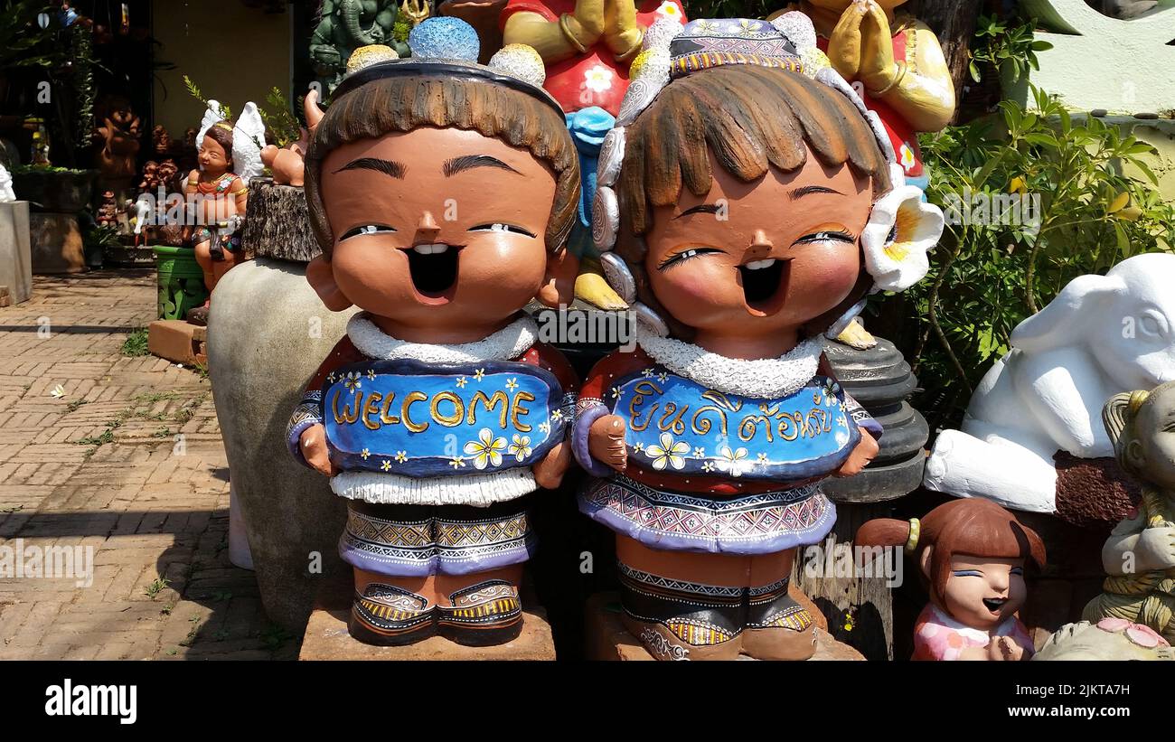 The clay statues with a welcome sign, representing boy and girl in a ...