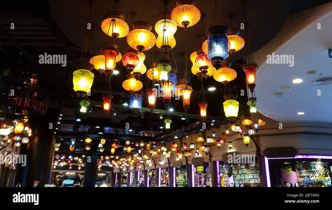 Illuminated lamps decorating the ceiling of a shopping mall in Bangkok ...