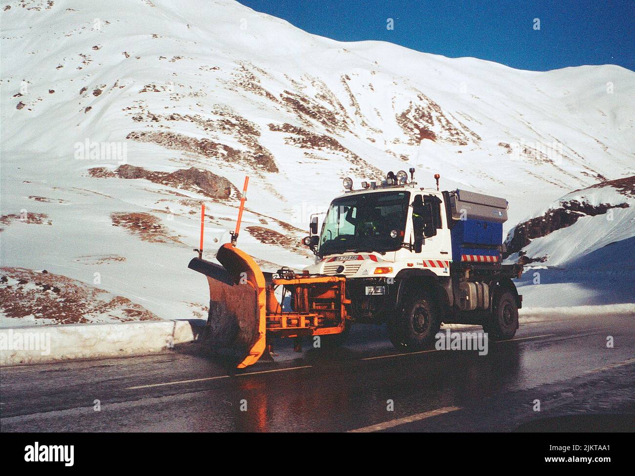 Classic and white snowplow truck in the road. Mercedes Benz Unimog U500 ...